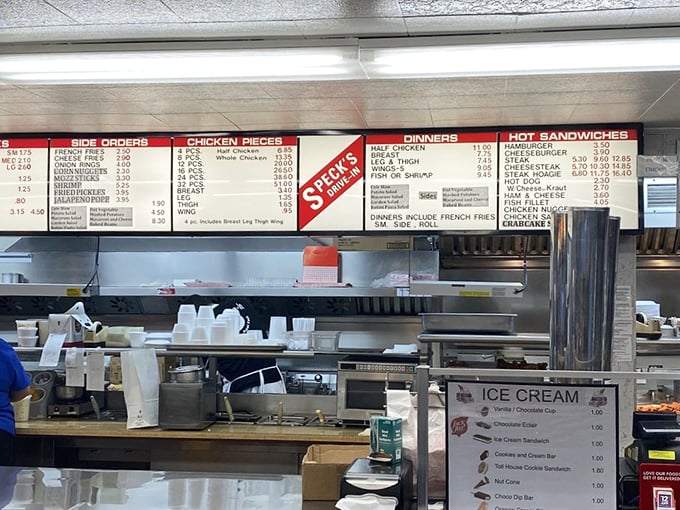 The menu board tells a simple story: chicken pieces, dinners, and sandwiches—no fancy descriptions needed when the food speaks for itself.