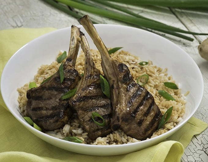 Meat lollipops for grown-ups! Perfectly grilled lamb chops perched atop aromatic rice – proof that sometimes the simplest dishes are the most spectacular.