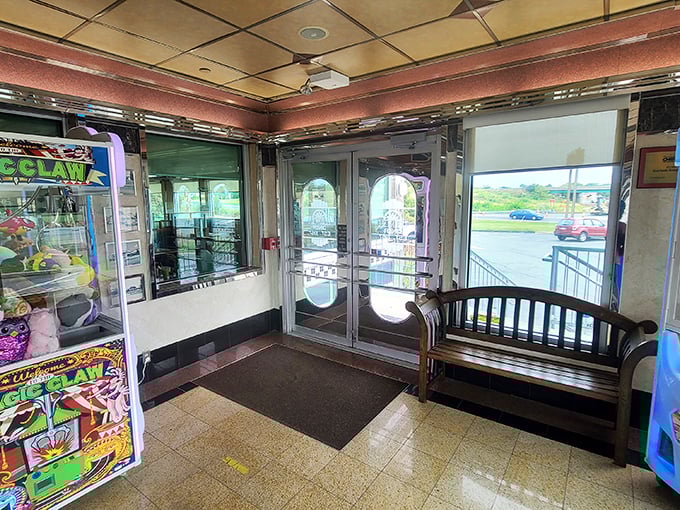 The entrance area – half nostalgic time portal, half promise of good things to come, with a claw machine that's seen more quarters than a laundromat.