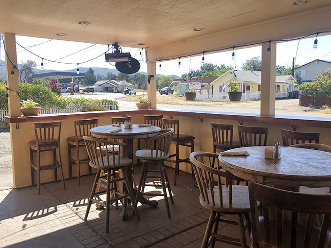 Simple wooden chairs, round tables, and mountain views—a reminder that the best dining experiences often come without white tablecloths or complicated menus.