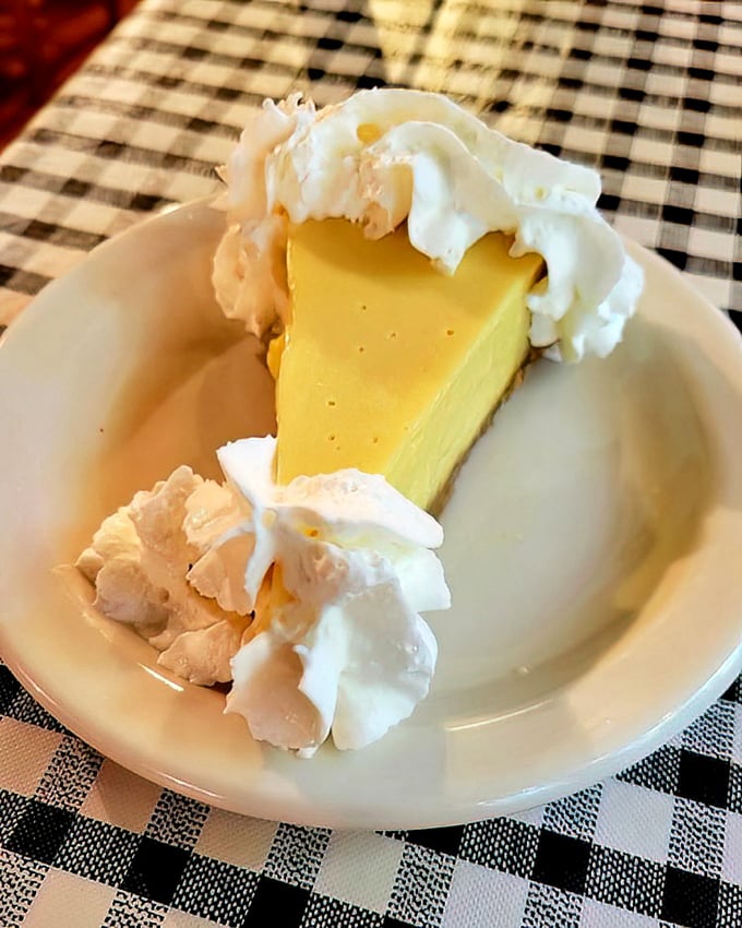Key Lime Pie that strikes the perfect balance between sweet and tart – a slice of Florida sunshine topped with clouds of whipped cream.