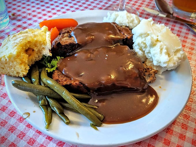 Meatloaf drowning in gravy alongside vegetables that actually taste like vegetables – imagine that revolutionary concept.