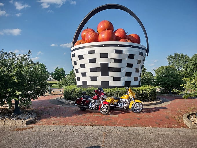 Even motorcyclists can't resist stopping for a photo op with this roadside giant, their colorful bikes adding scale to the massive creation.