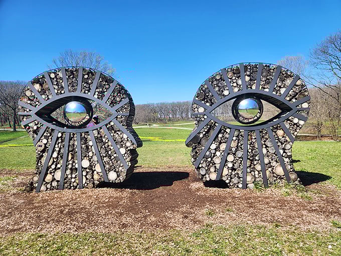 Two faces locked in eternal conversation, their eyes reflecting the landscape they observe—nature watching us watching nature in infinite recursion.