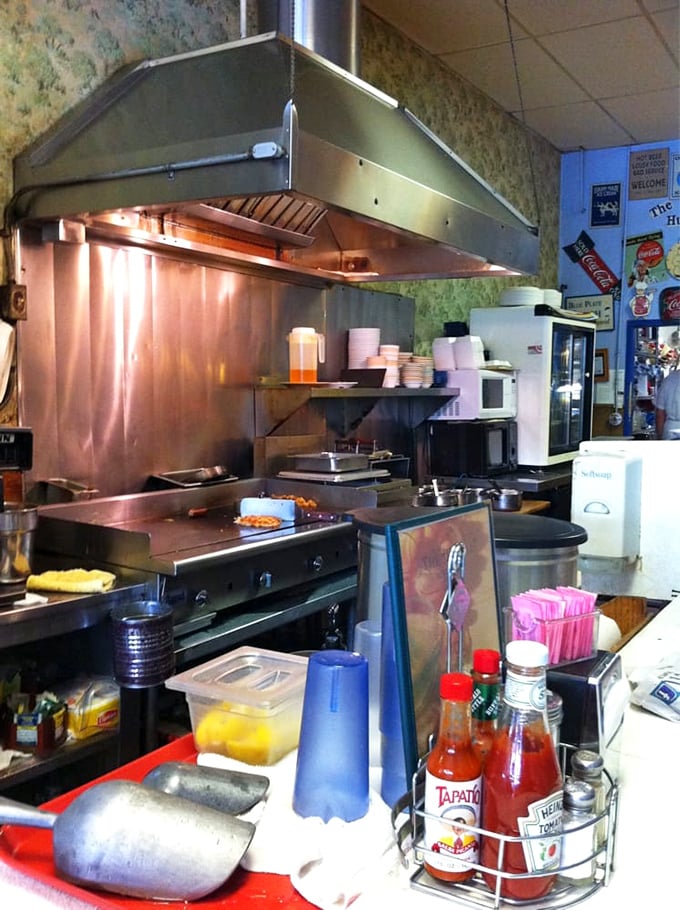 The open kitchen—where breakfast symphonies are composed on a well-seasoned grill that could tell stories if it could talk.