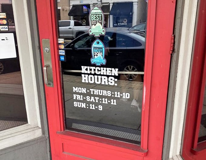 Kitchen hours posted prominently—because knowing when you can get your cod fix is essential information for planning your week.
