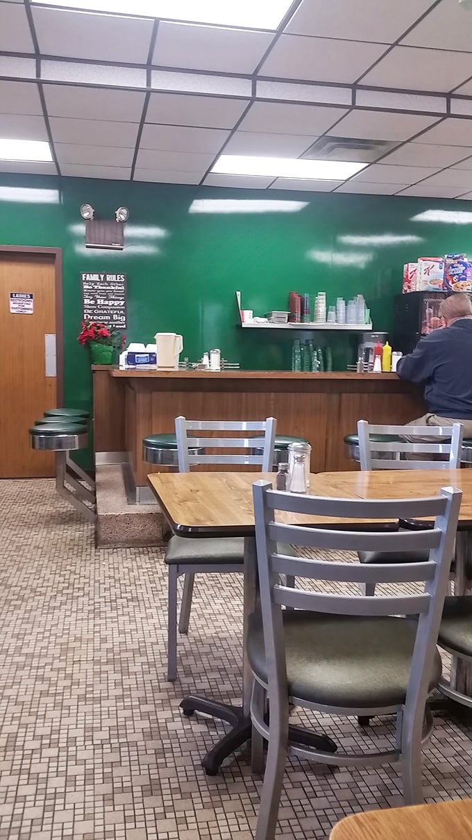 The green walls and wooden accents create that perfect old-school diner vibe where calories don't count and coffee refills flow freely.
