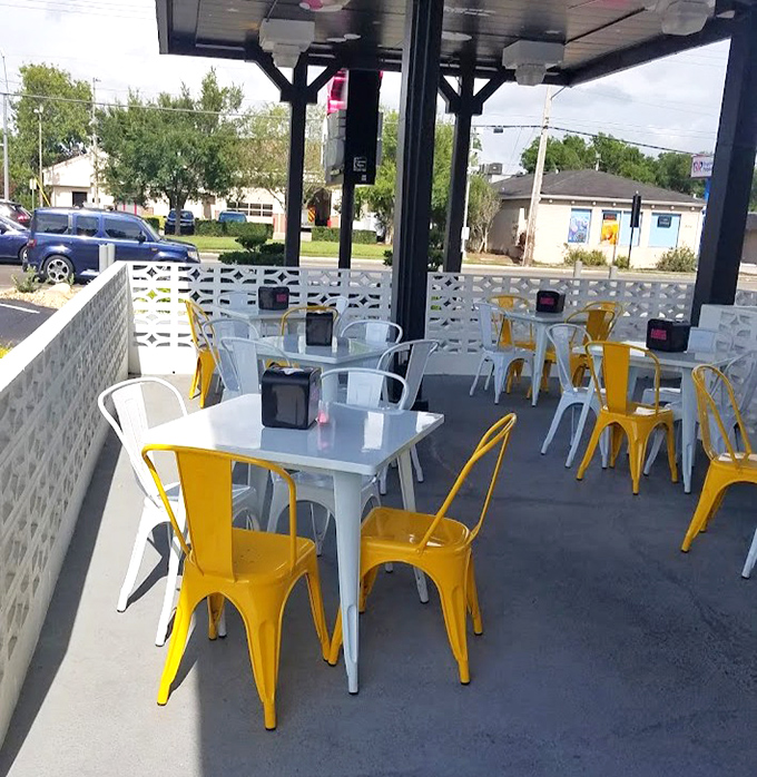 Yellow and white metal chairs dot the outdoor patio – a cheerful spot to recover from flavor overload while plotting your next chicken adventure.