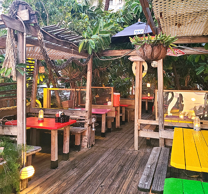 Rustic wooden tables under a canopy of tropical plants create the perfect setting for marathon meals where time slows to a delicious crawl.