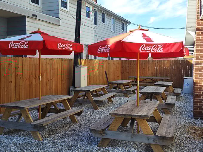The outdoor seating area—where picnic tables become thrones and every bite tastes better under those Coca-Cola umbrellas.