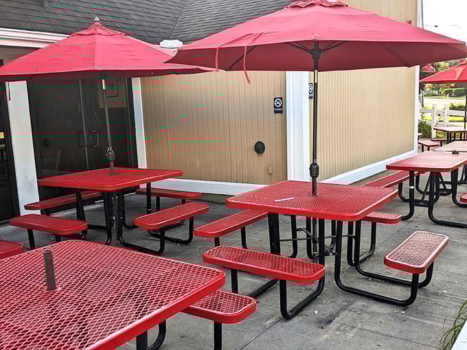 Red tables under bright umbrellas—the perfect spot for summer feasting. Because sometimes BBQ tastes even better with a side of fresh air.