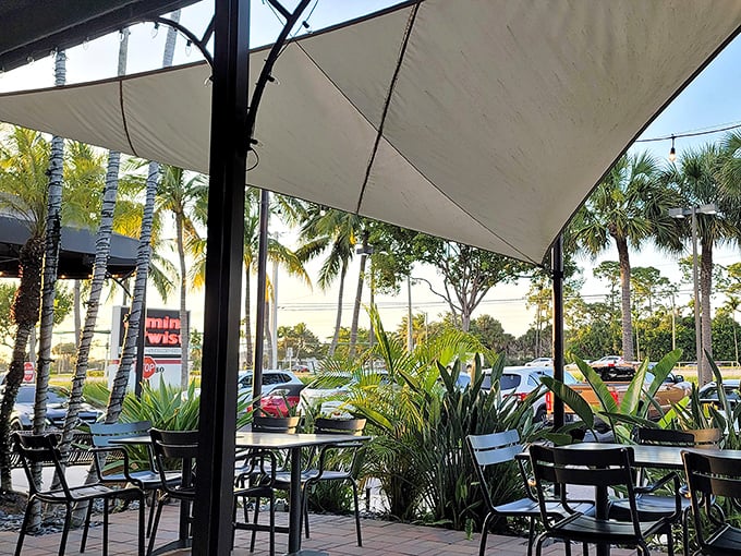 The outdoor patio – where Florida breezes carry conversations and laughter while palm trees provide nature's perfect backdrop for alfresco dining.