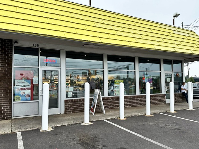 The storefront's white bollards stand guard like sentinels protecting the precious cargo inside. The "OPEN" sign – two syllables of pure joy.