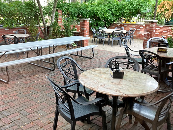 The brick patio offers a peaceful retreat for outdoor dining. Those tables have hosted first dates, family reunions, and countless "let's catch up" moments.