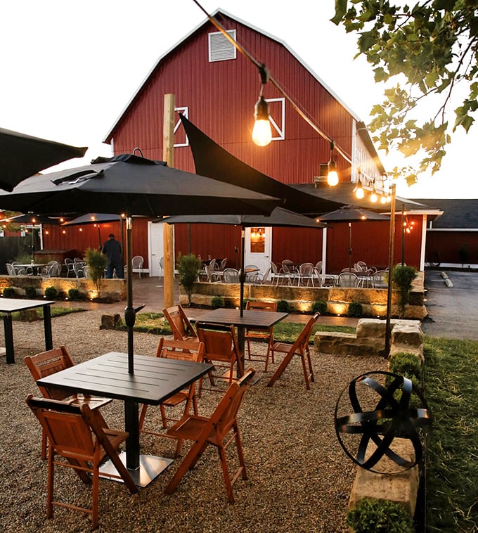 As twilight falls, the outdoor seating area transforms into a magical space where string lights compete with fireflies for atmospheric rights.