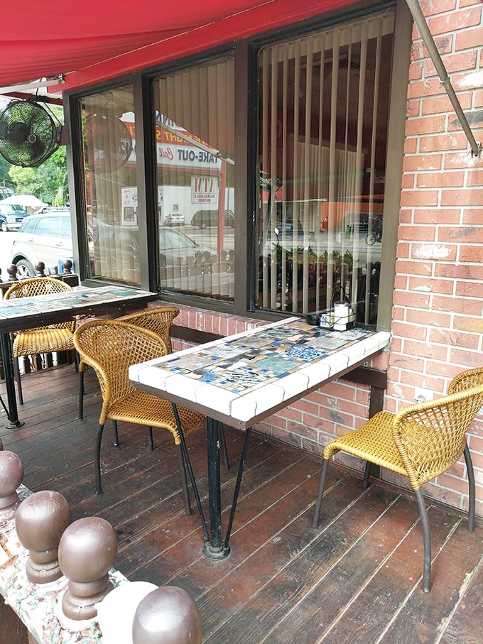 Outdoor seating with charming mosaic tables—where Florida's weather and Three Coins' cooking create the perfect dining alliance.