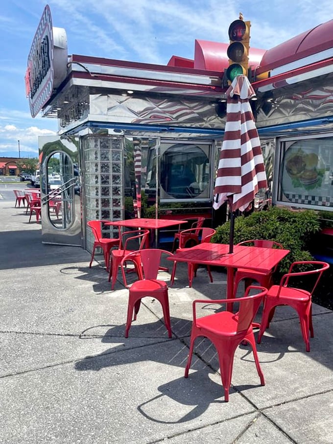 Al fresco dining, diner-style—where the red tables and chairs are as vibrant as the flavors waiting for you inside.