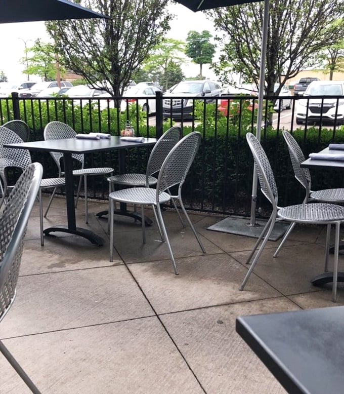The outdoor patio offers fresh air dining surrounded by greenery—Michigan summers were made for moments like this.