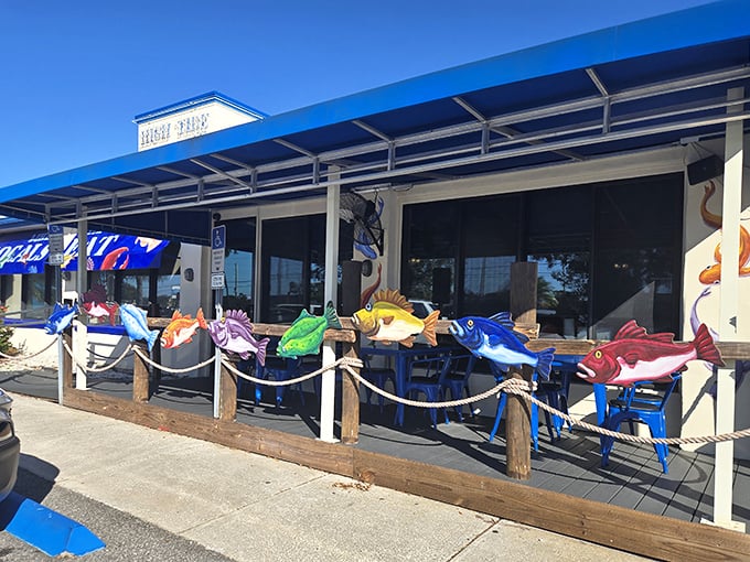 Outdoor seating guarded by a colorful school of wooden fish – like sentinels ensuring only the seafood-worthy may pass through these hallowed doors.