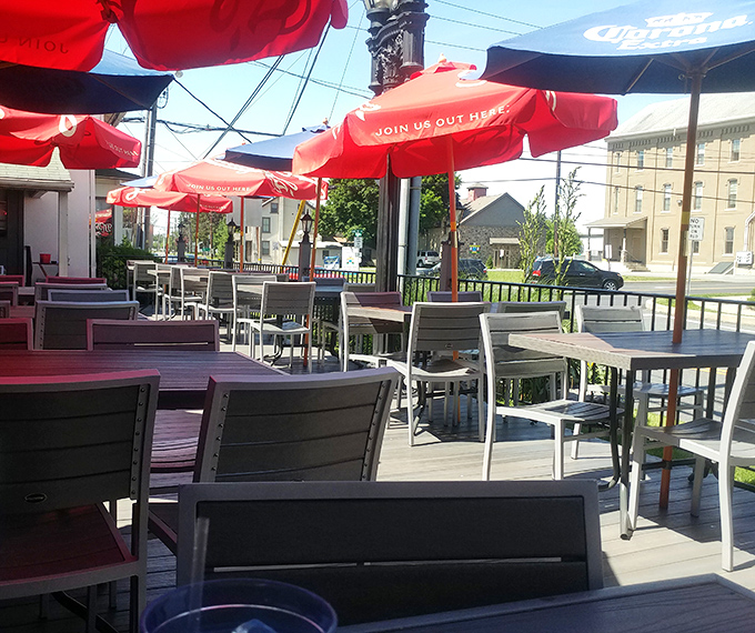 Red umbrellas create islands of shade on the outdoor patio – Pennsylvania's answer to European café culture, with better portion sizes.