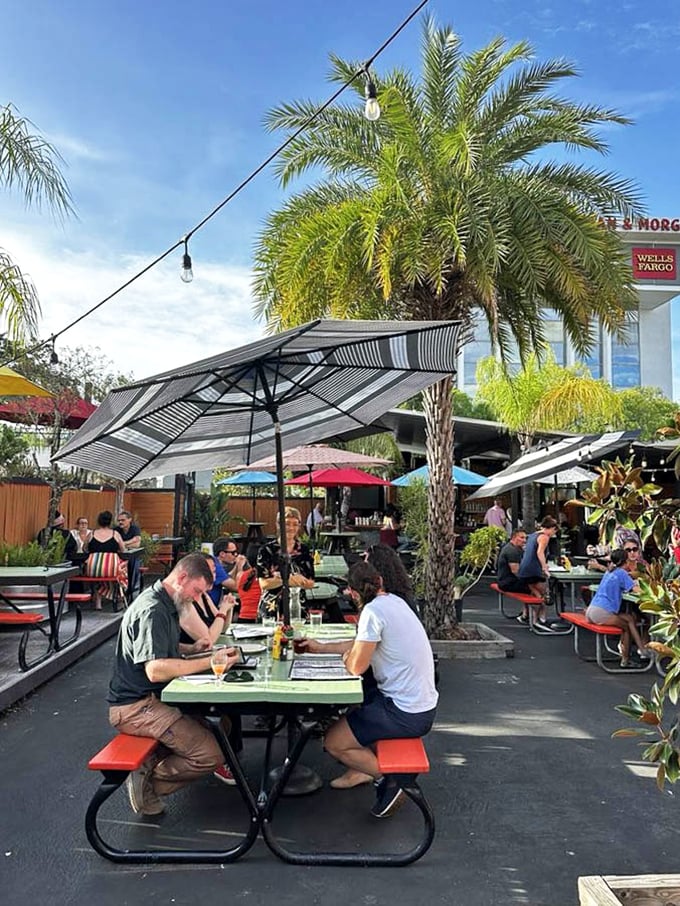 The outdoor patio offers Florida sunshine with a side of people-watching – palm trees included at no extra charge.