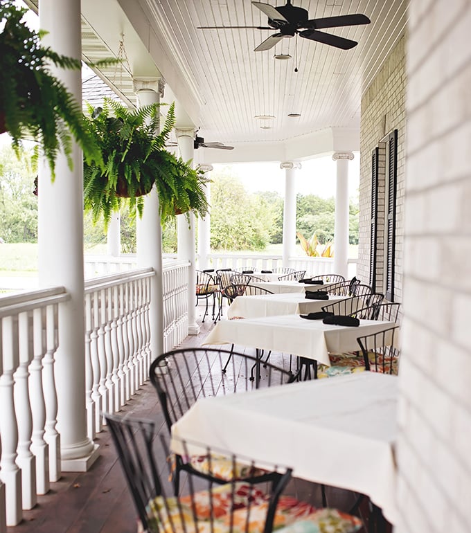 Porch seating that begs you to linger over coffee and dessert. Those hanging ferns aren't just decoration—they're part of the ambiance.