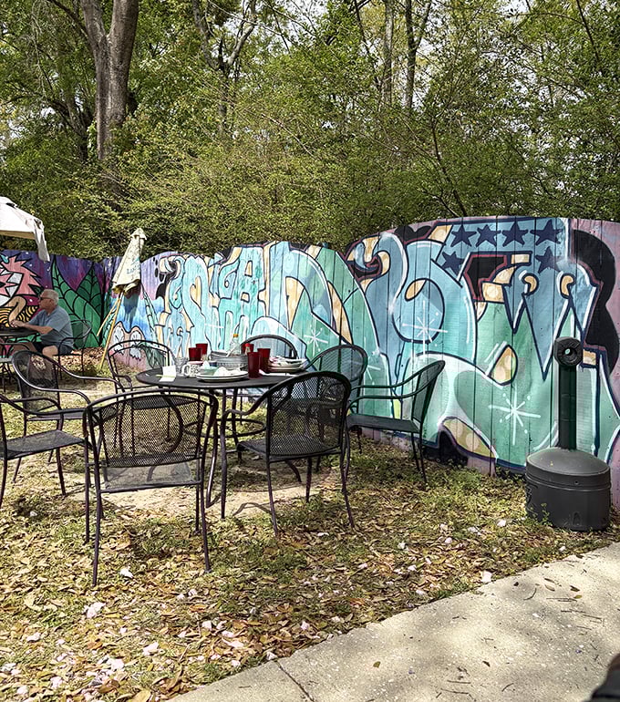 The outdoor seating area where graffiti art meets garden party – only in Tallahassee, friends.