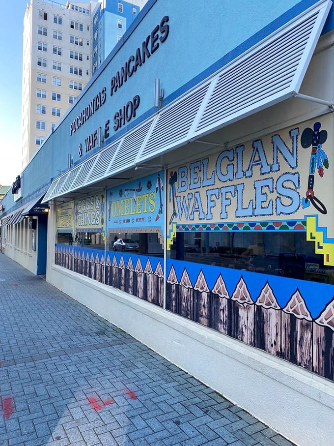 The exterior proudly announces its breakfast specialties—Belgian waffles and omelets that have been drawing crowds to this oceanfront spot for generations.