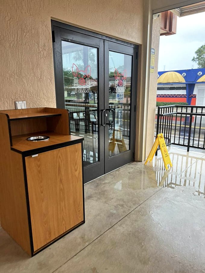 The entrance to meat paradise isn't pearly gates – it's glass doors with a pig logo. That yellow caution sign might as well say "Warning: Extreme Deliciousness Ahead."