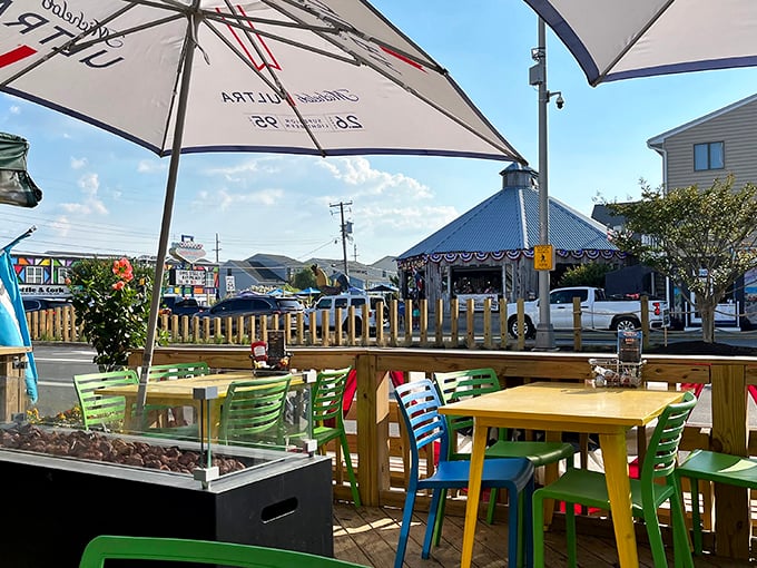 Colorful outdoor seating under market umbrellas—where the ocean breeze enhances every bite and summer seems eternal.