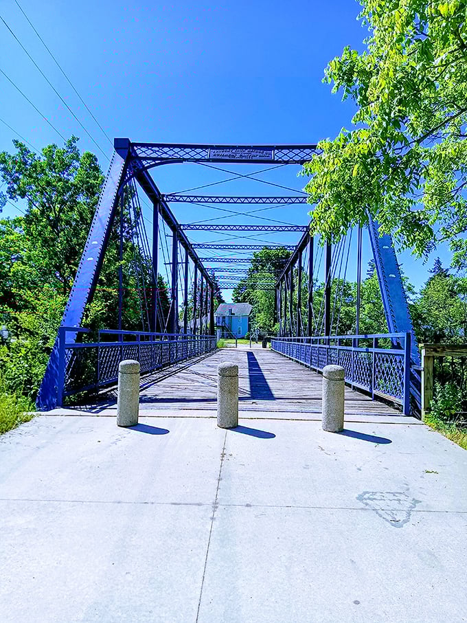 This blue bridge isn't just functional infrastructure – it's a pathway to Owosso's natural beauty, inviting exploration and peaceful wandering.