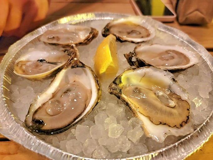 Fresh oysters on ice with a squeeze of lemon—nature's perfect appetizer and the ocean's most elegant calling card, glistening like jewels from the deep.