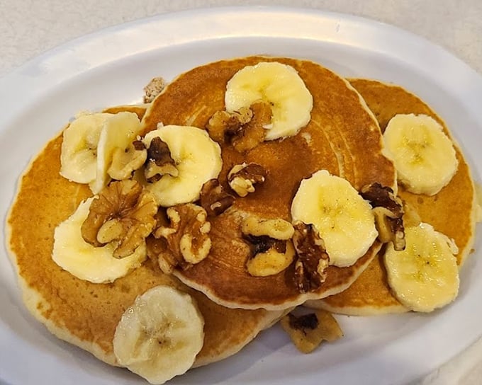 Pancakes adorned with bananas and walnuts – nature's way of suggesting that dessert for breakfast is perfectly acceptable adult behavior.