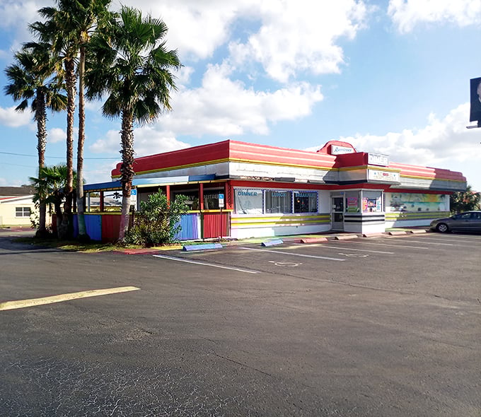 The modest exterior belies the time-traveling experience within – palm trees adding that distinctly Florida touch to 1950s nostalgia.