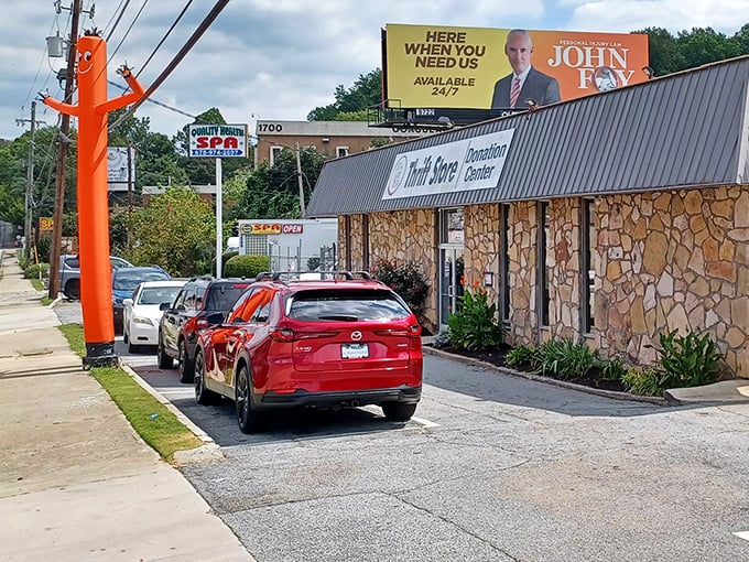 The parking lot fills quickly on busy days. That bright orange inflatable figure seems to wave "hurry up—the good stuff's going fast!"