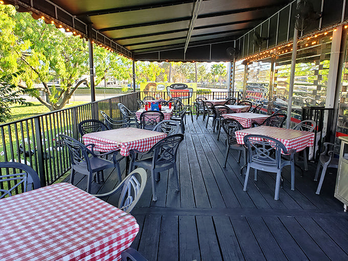 The outdoor seating area with its checkered tablecloths isn't just dining al fresco—it's Florida's answer to Parisian café culture.
