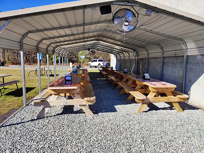 The outdoor seating area offers picnic-table charm under a simple shelter. Sometimes the best meals happen with a side of fresh air.