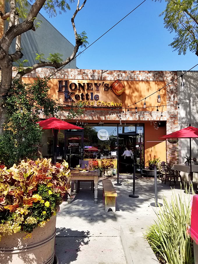 The inviting patio entrance, with its colorful planters and string lights, offers a sunny spot to enjoy your Southern feast.