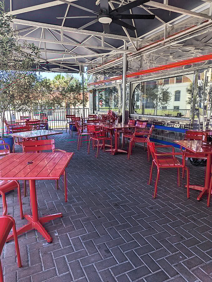 Florida sunshine meets diner charm on this outdoor patio, where red tables invite you to enjoy your breakfast with a side of fresh air.