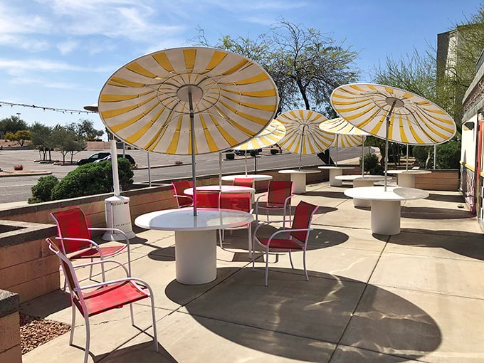 Arizona sunshine meets outdoor dining under cheerful yellow umbrellas—the perfect spot to enjoy your coffee while desert breezes keep you cool.