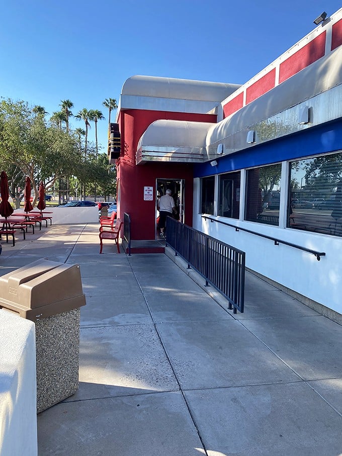 The waiting area features the essential diner checkerboard floor and walls adorned with memories—visual appetizers before the main event.