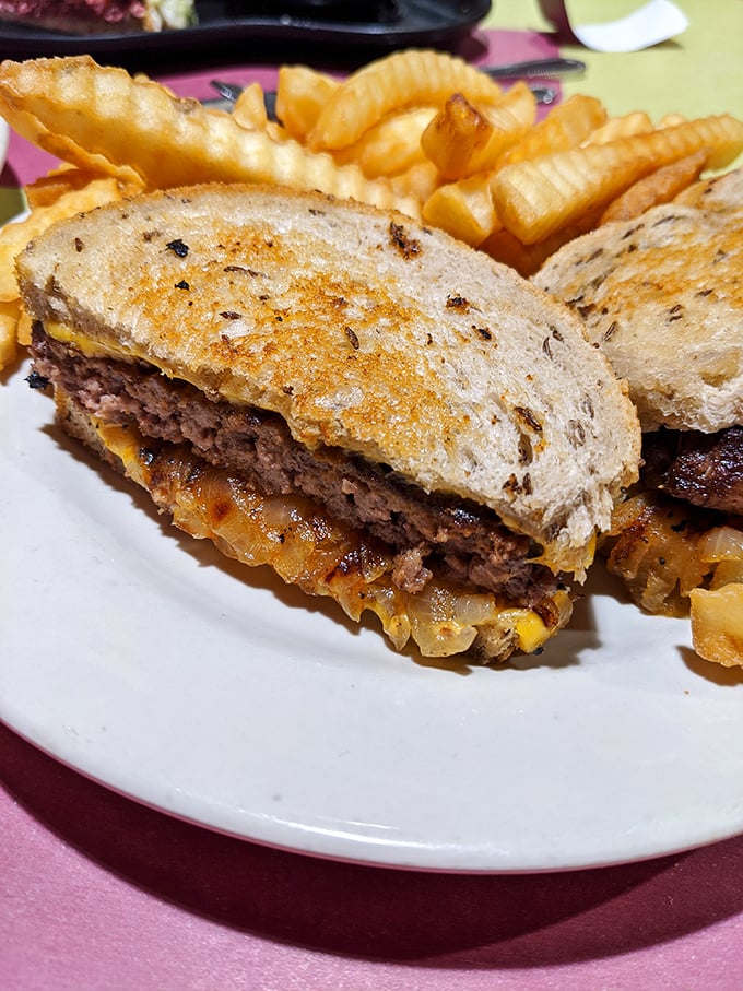 This patty melt with golden fries isn't just lunch – it's a masterclass in how grilled onions and melted cheese can solve most of life's problems.