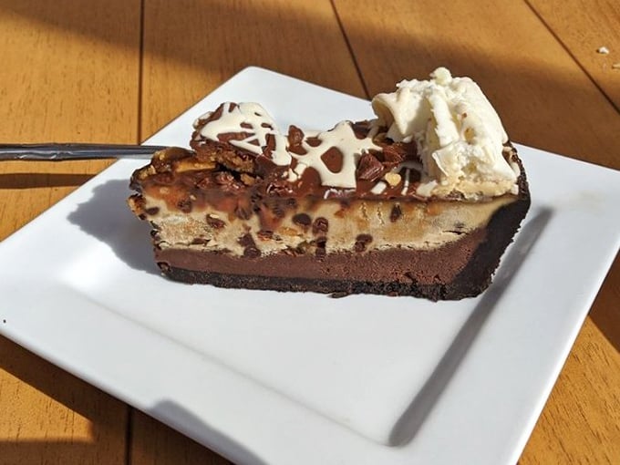 Layer upon layer of chocolate and peanut butter decadence. This slice doesn't just end your meal—it becomes the reason you came.