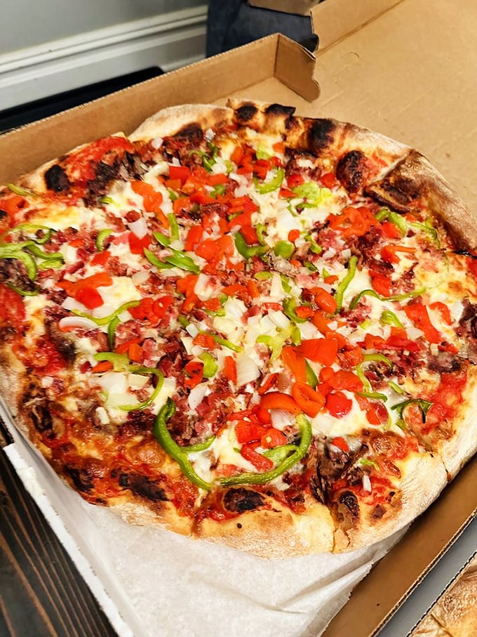 A symphony of colors and textures—the Philly steak pizza combines two regional favorites in one glorious, cheese-blanketed masterpiece.