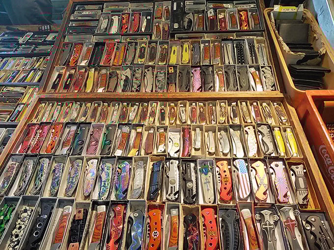 Pocket knives arranged with military precision create a mesmerizing grid of potential purchases—tools that grandpas everywhere would approve of.