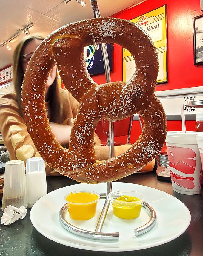The pretzel isn't just big—it's Ohio-ambitious, suspended dramatically like edible performance art with mustard dipping sauce as its supporting actor.