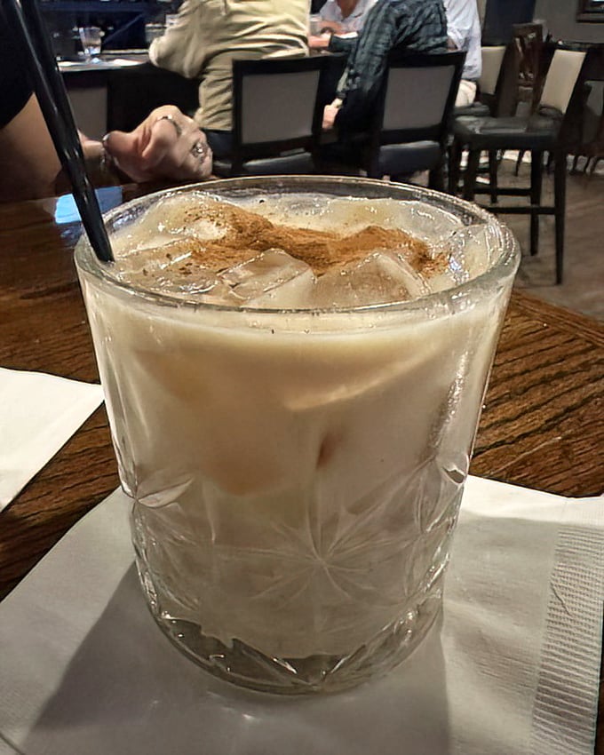 A White Russian with autumn ambitions. That cinnamon dusting isn't just garnish—it's the difference between a drink and an experience.