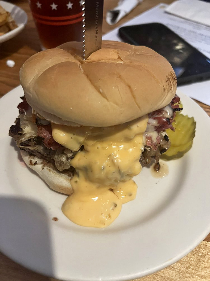 Cheese sauce isn't just a topping here—it's a philosophy. This burger embraces excess in all the right ways, demanding both napkins and respect.