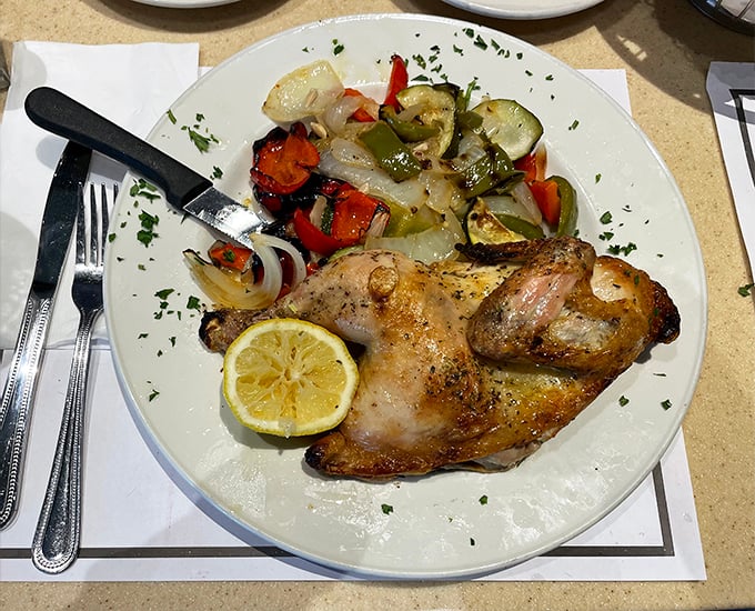Roasted chicken that looks like it just posed for its glamour shot. Those vegetables aren't side dishes—they're supporting actors in a delicious drama.