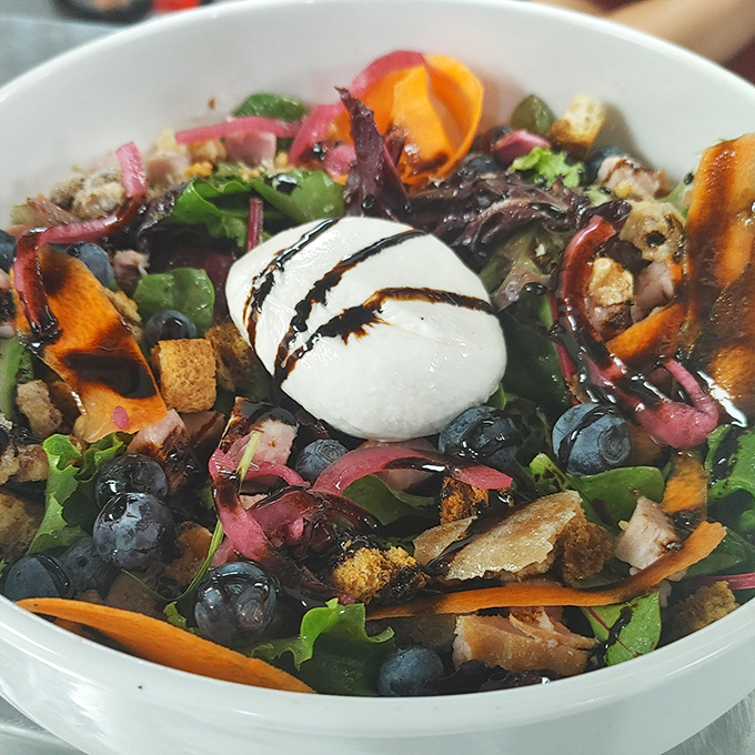 A salad that actually excites – fresh greens playing host to a party of blueberries, pickled onions, and a creamy cheese centerpiece.